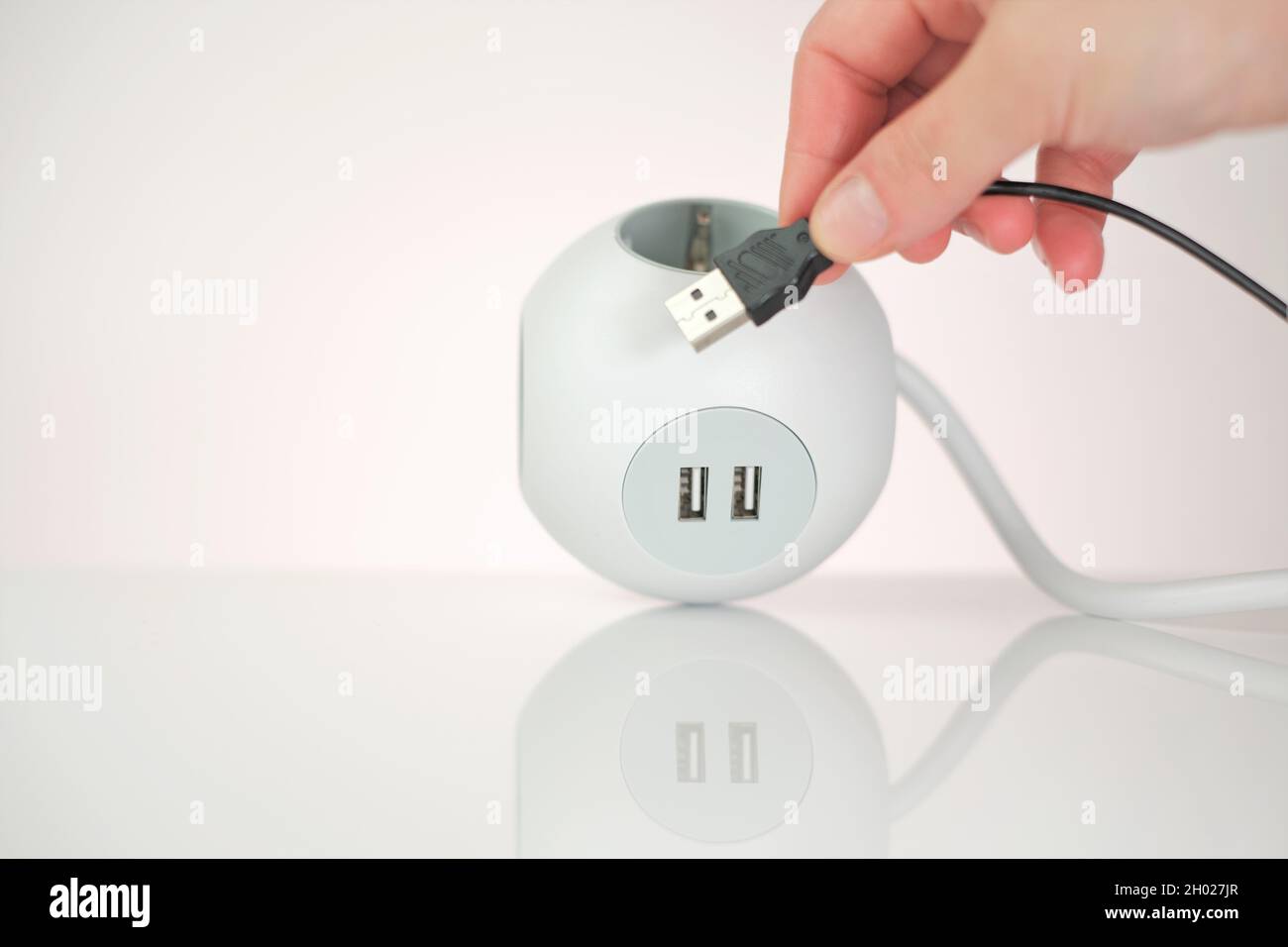 USB adapter.Socket with USB connector. Hands include the USB cable in ...