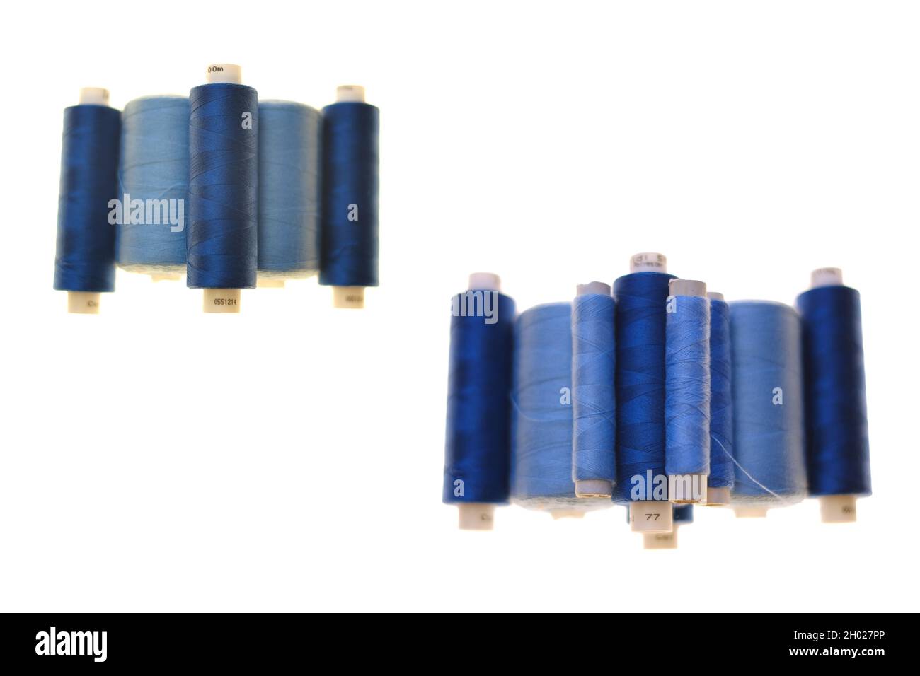 Sewing threads set.Blue and gray thread spools isolated on white ...