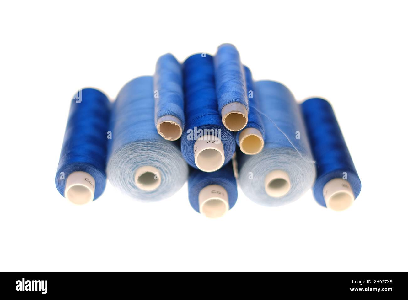 Sewing threads.Blue and gray thread spools isolated on white background ...