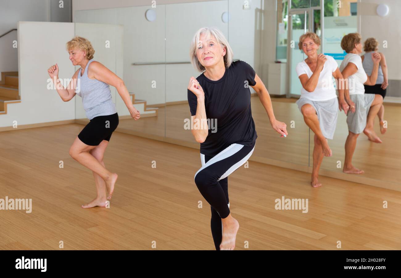 Positive aged woman practicing vigorous dance movements Stock Photo - Alamy