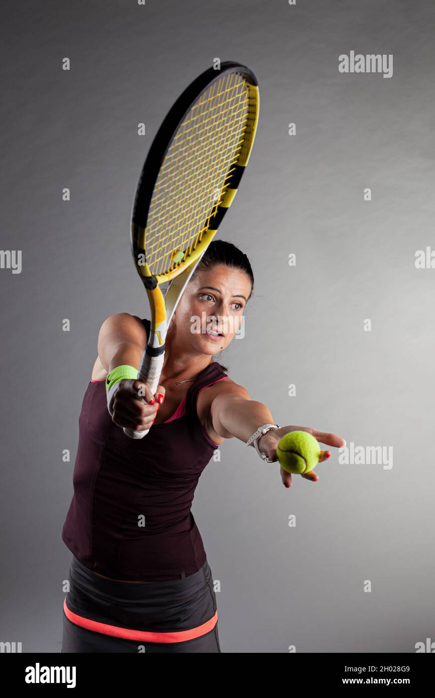Professional female tennis player. Girl swinging racket Stock Photo - Alamy