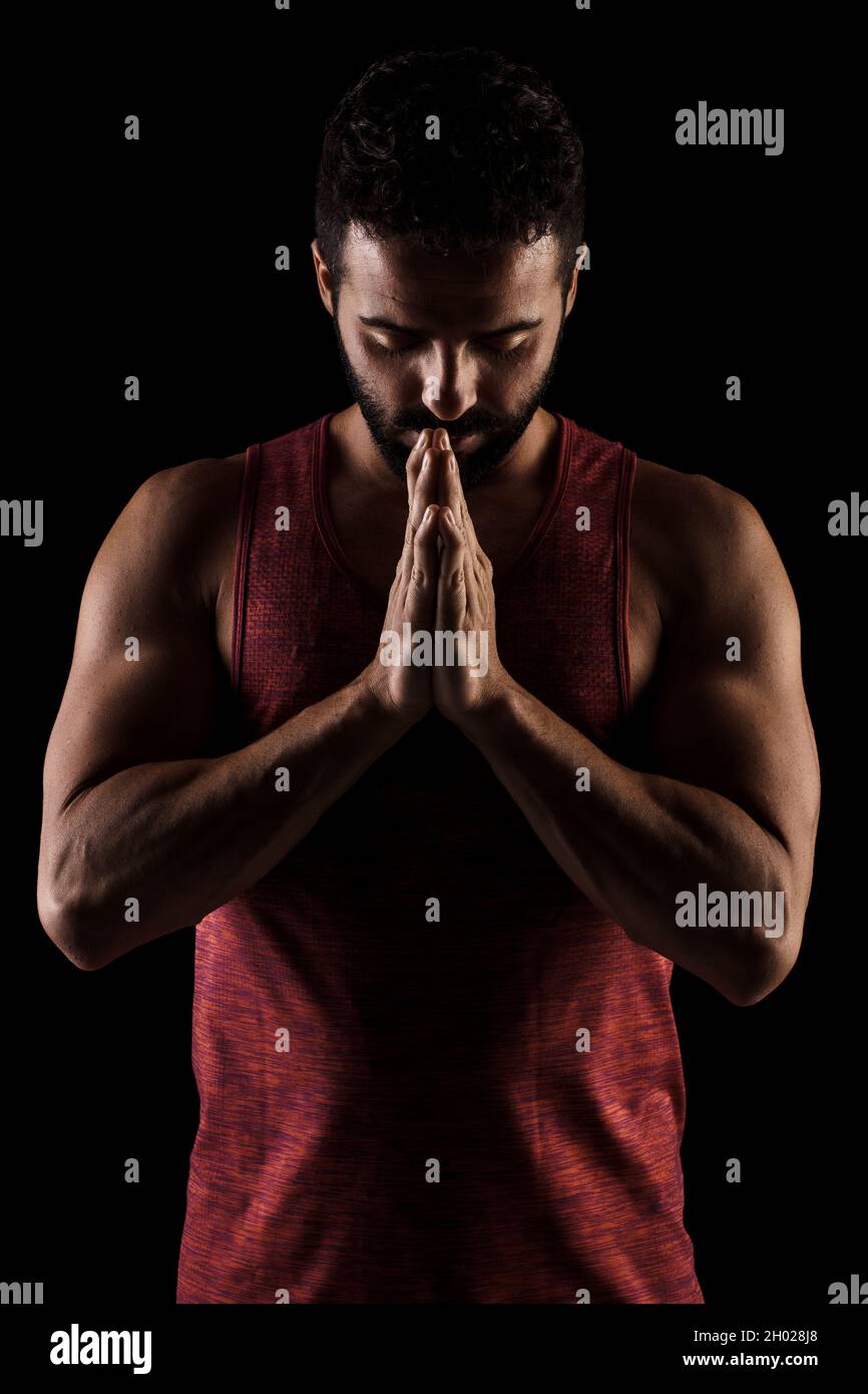 Side lit muscular Caucasian man silhouette. Athlete in red shirt ...