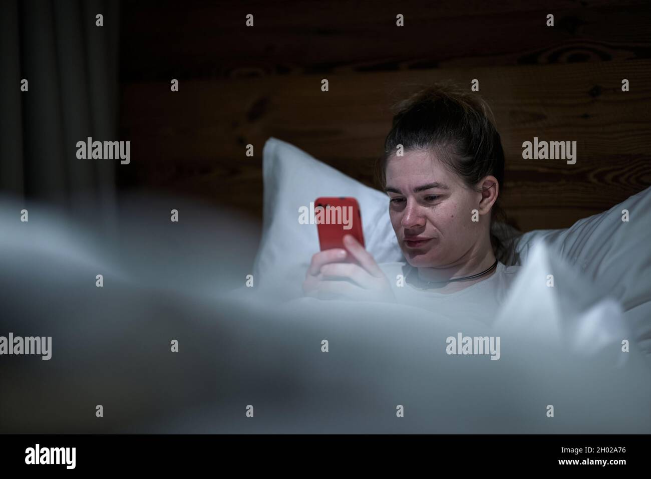 Smartphone usage in bed at night Stock Photo - Alamy