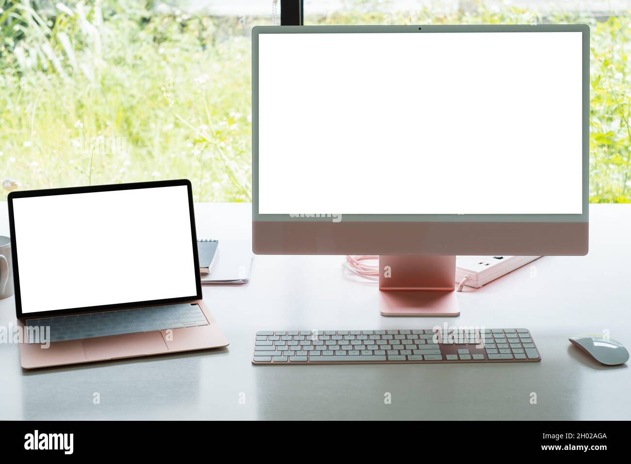 White blank screen monitor and laptop on modern working desk Stock ...