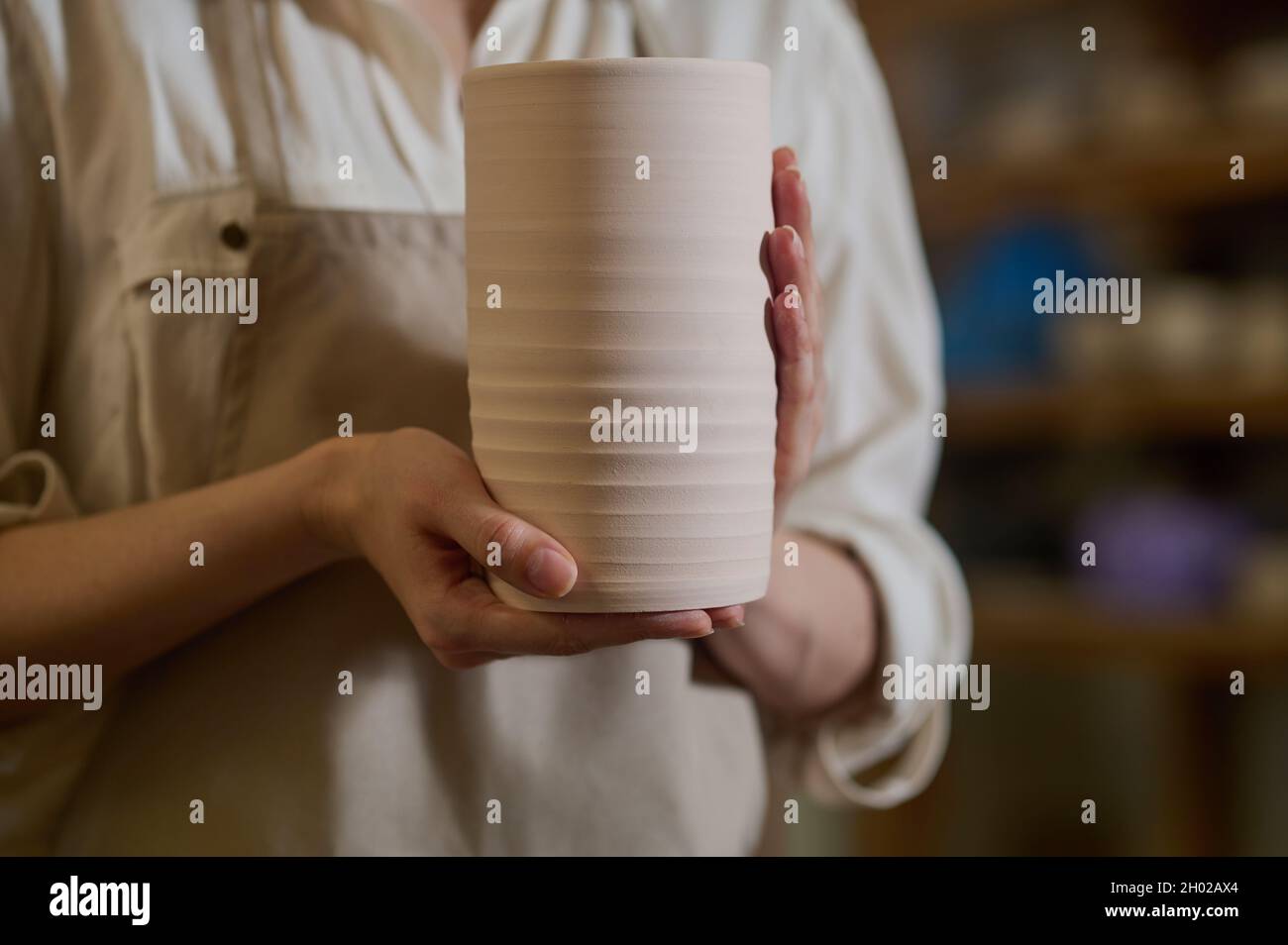 Hands of a potter with a newly made pot Stock Photo - Alamy