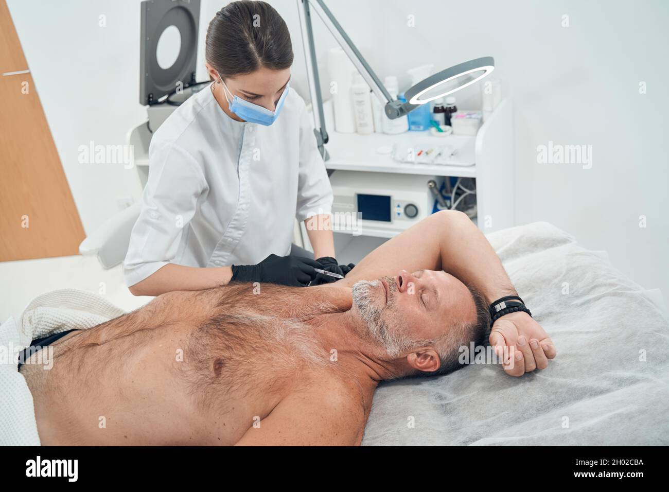 Male person receiving underarm treatment in cosmetology clinic Stock ...