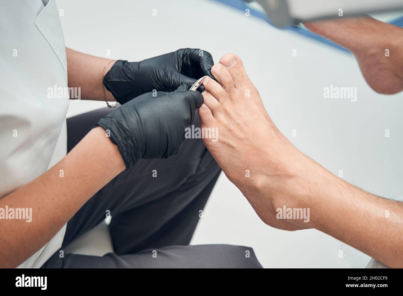Pedicure master cutting man toenails in cosmetology salon Stock Photo ...