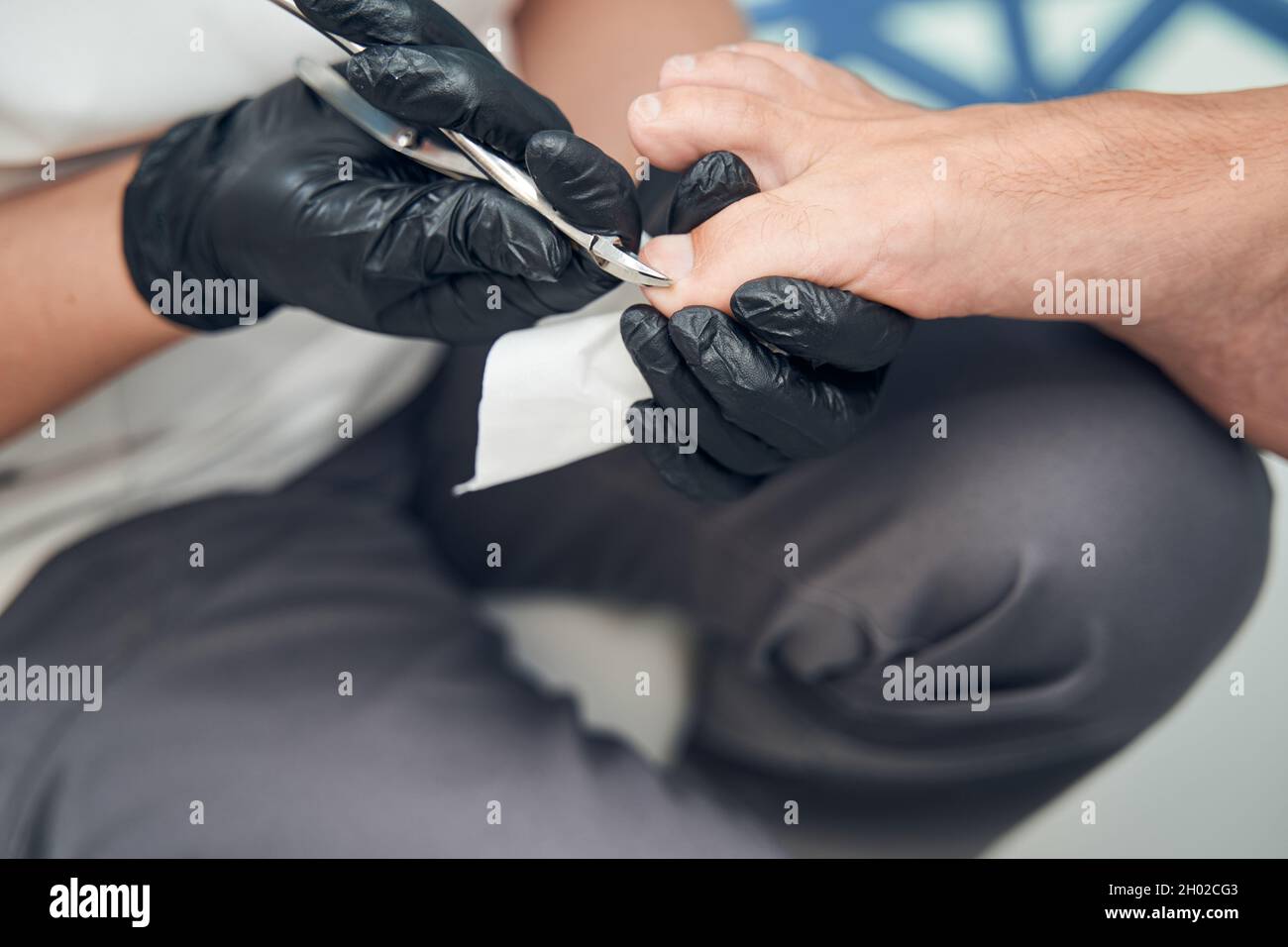 Pedicure specialist cutting man toenails in cosmetology salon Stock ...