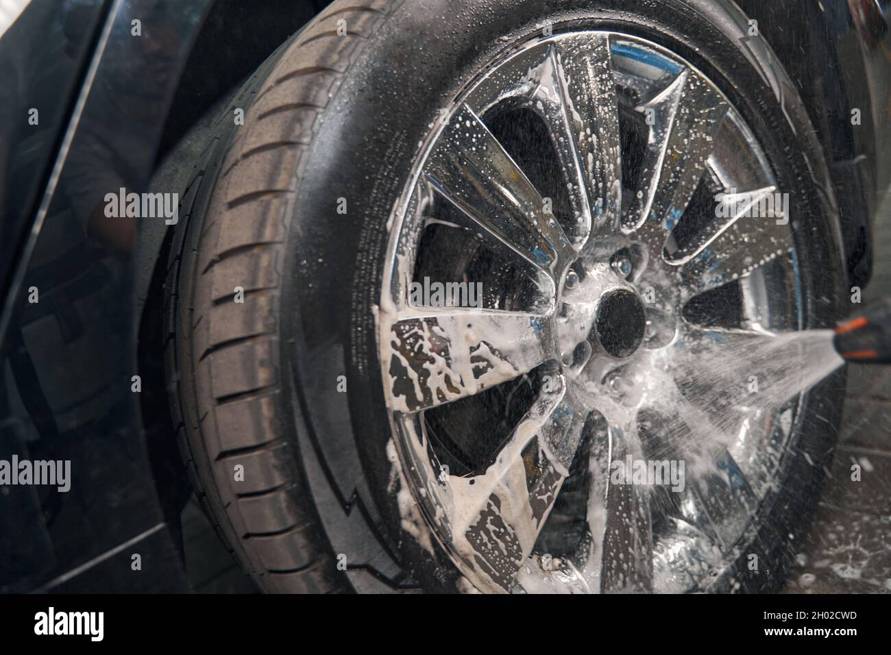 Car wheels washing by high pressure washer Stock Photo - Alamy