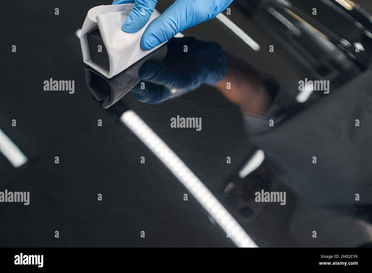 Car detailing worker applying ceramic coating on car varnish Stock ...