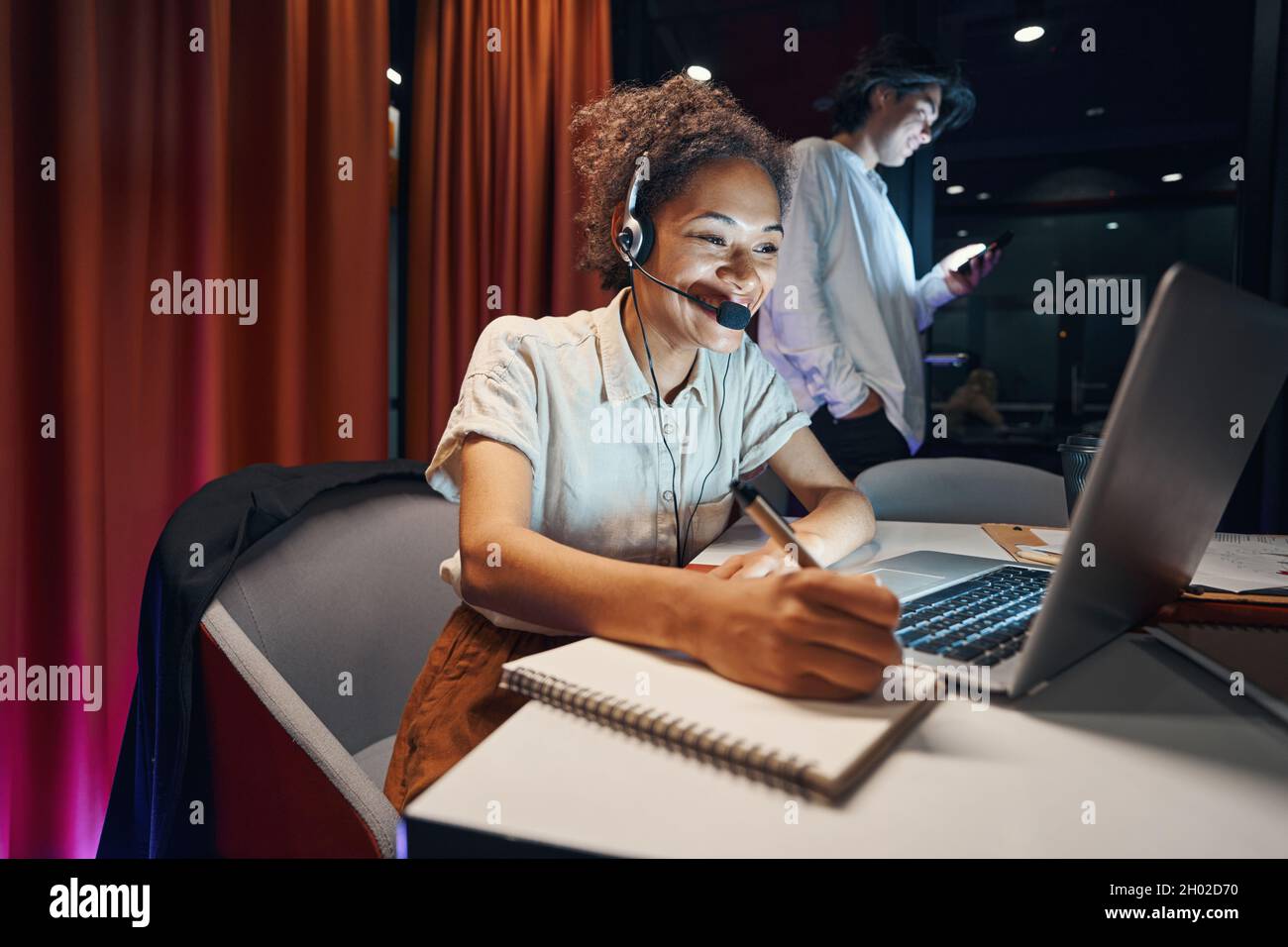 American woman working on laptop in cabinet Stock Photo - Alamy