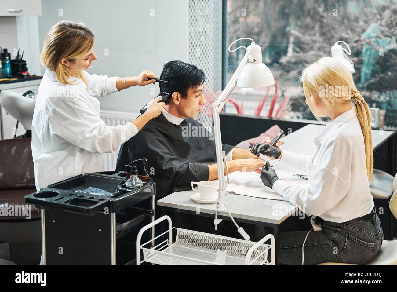 Male is using smartphone during beauty procedures Stock Photo - Alamy