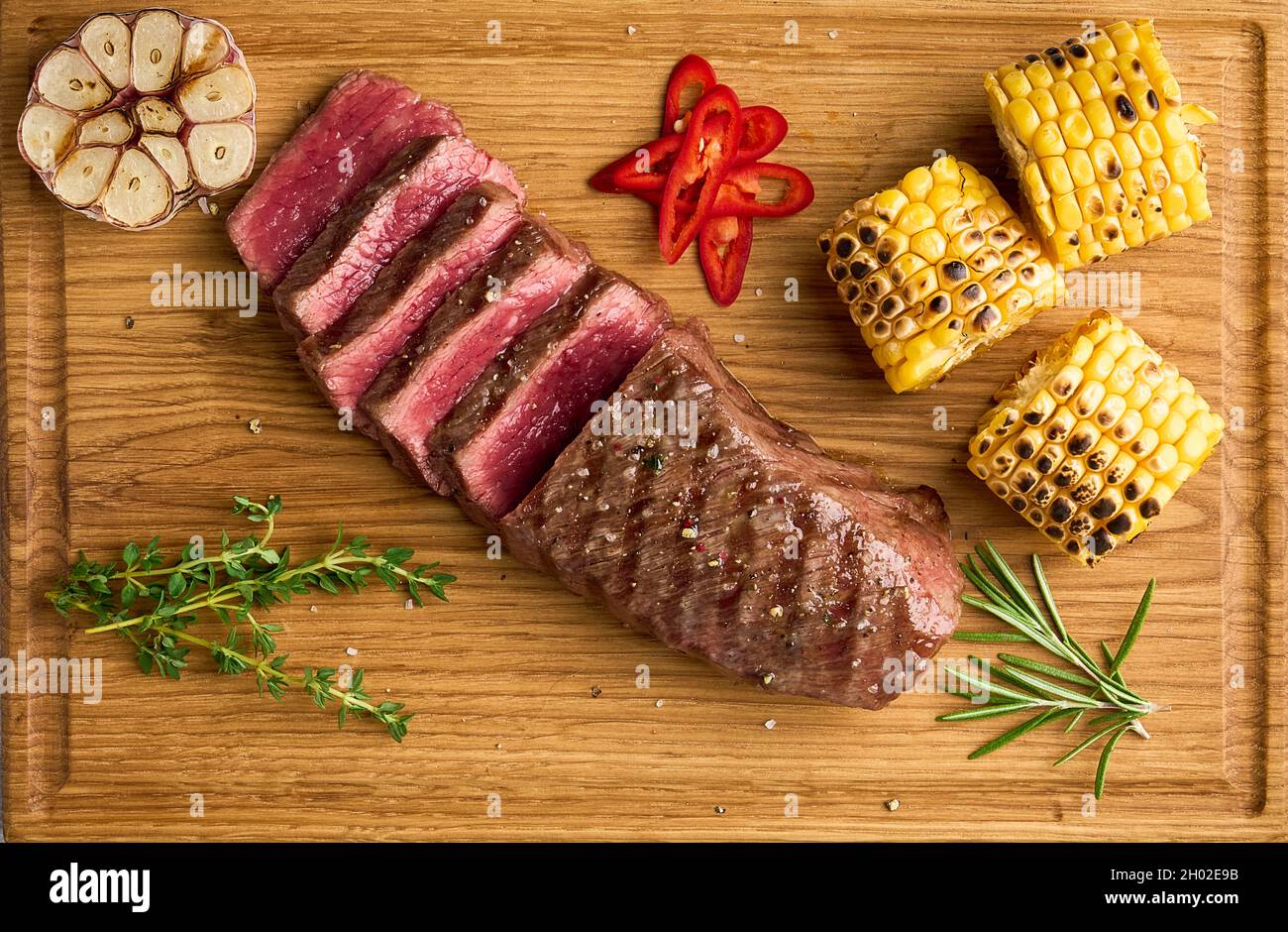 Rare striploin roasting. Tender and juicy sliced meat with condiments ...