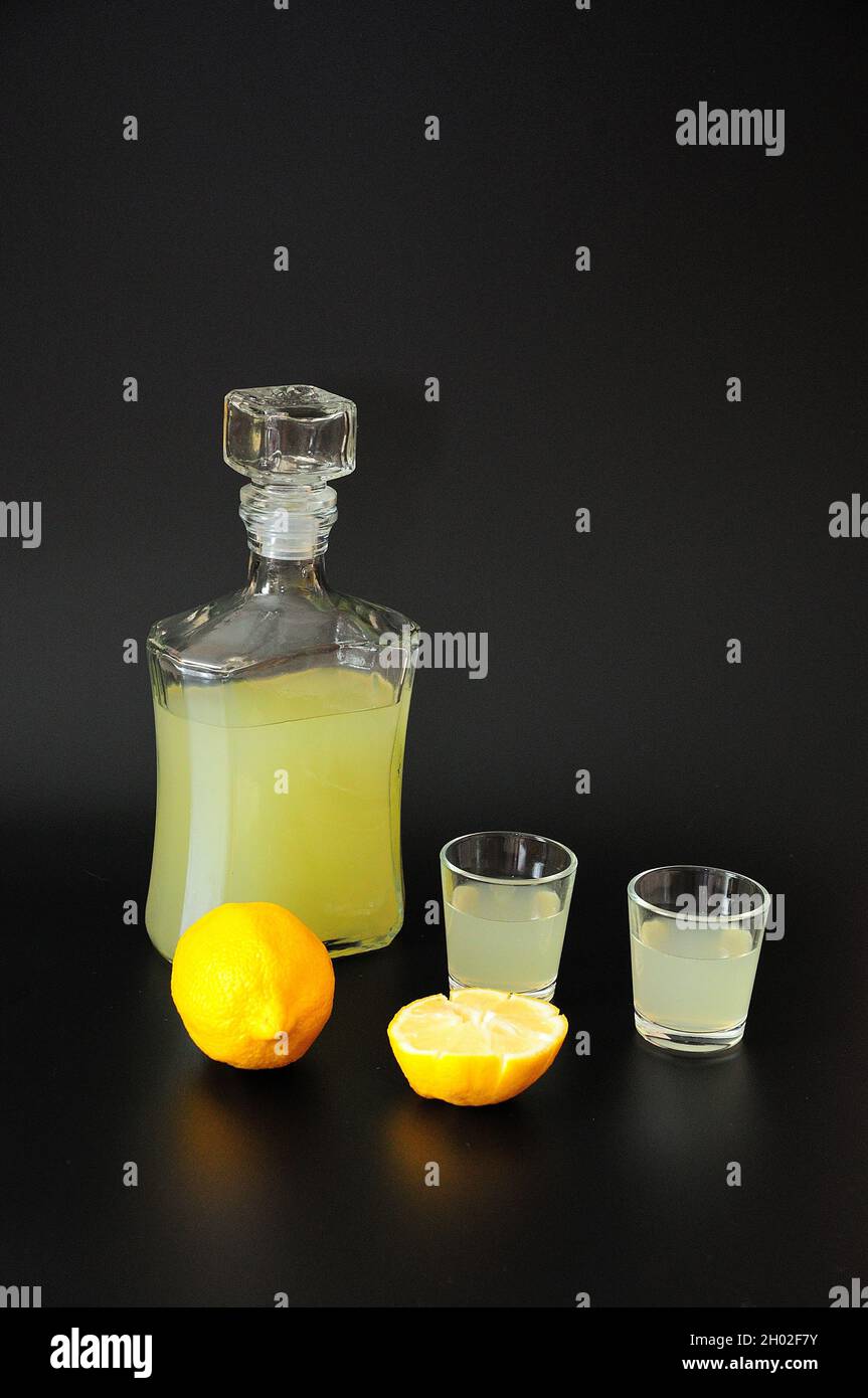 Traditional homemade Italian lemon-based liqueur, glass bottle and two ...