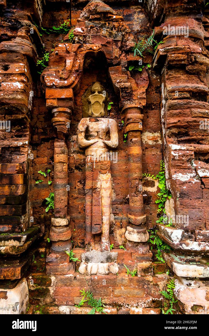 A statue embedded into one of the ancient brick buildings Stock Photo ...