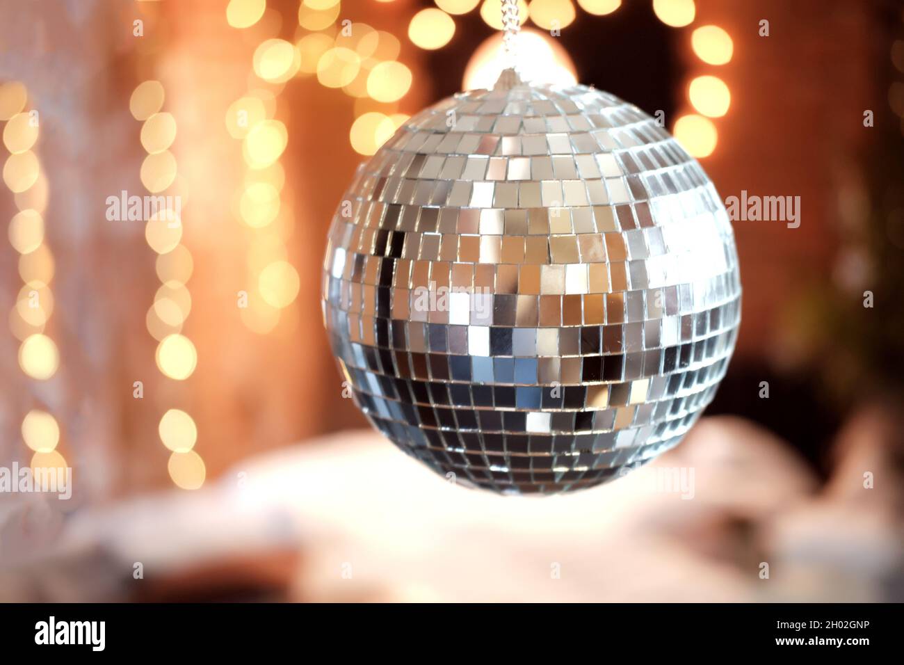 Shiny disco ball on night club close up. glowing ball in the room ...