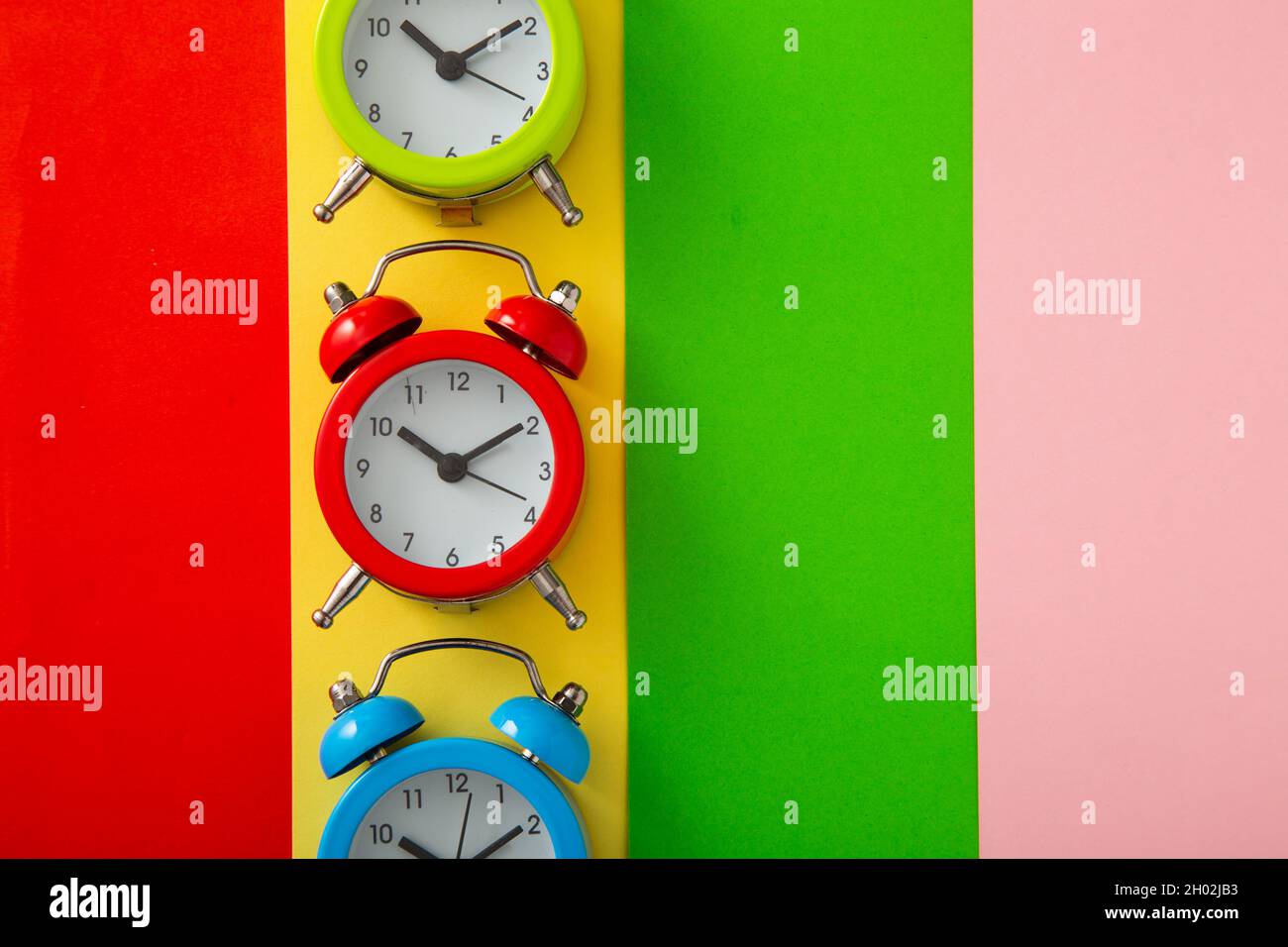 Colorful alarm clock on colorful background. (Flat lay Stock Photo - Alamy