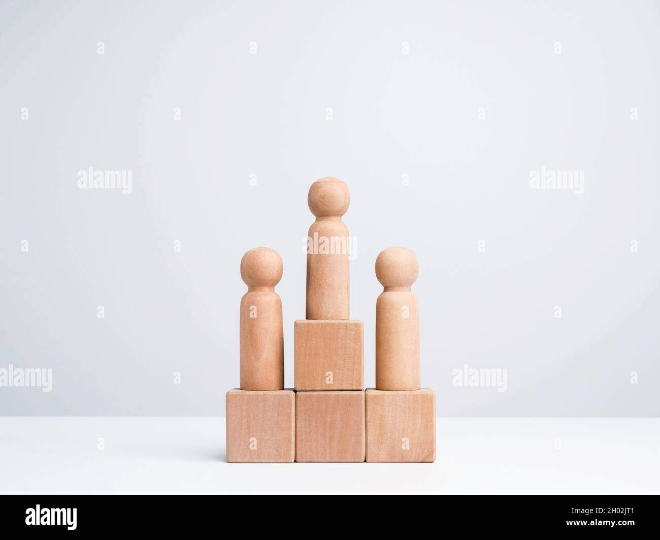 Business competition winner. The wooden figure standing on the winner ...