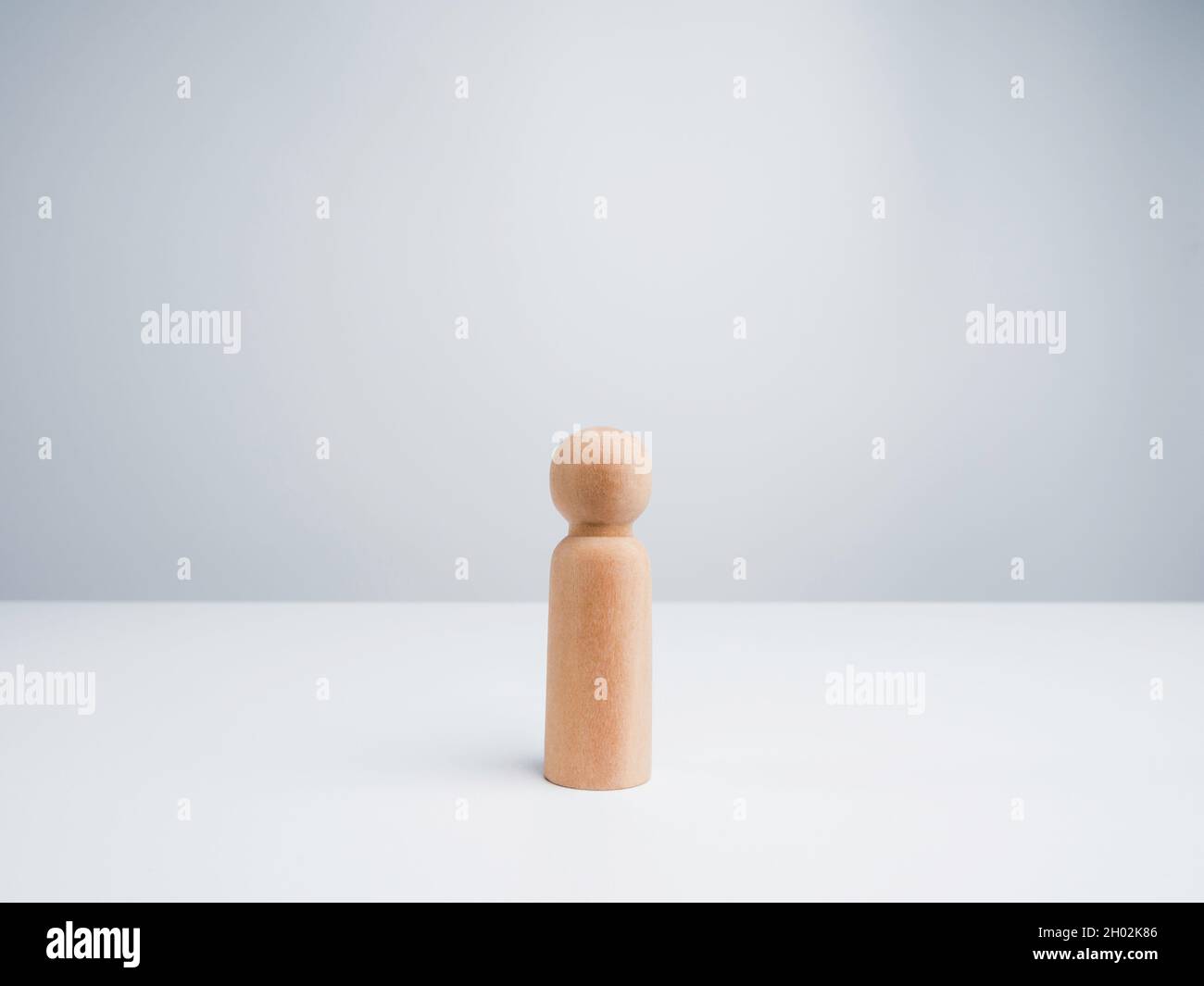 A wooden figure standing alone isolated on white background with copy ...