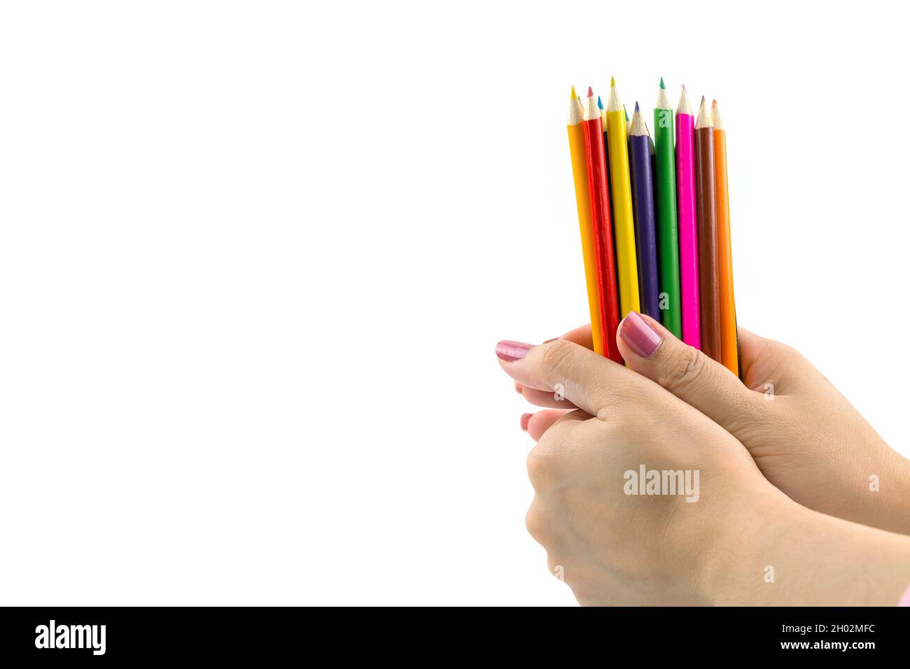Colored pencils in female hand on white background Stock Photo - Alamy