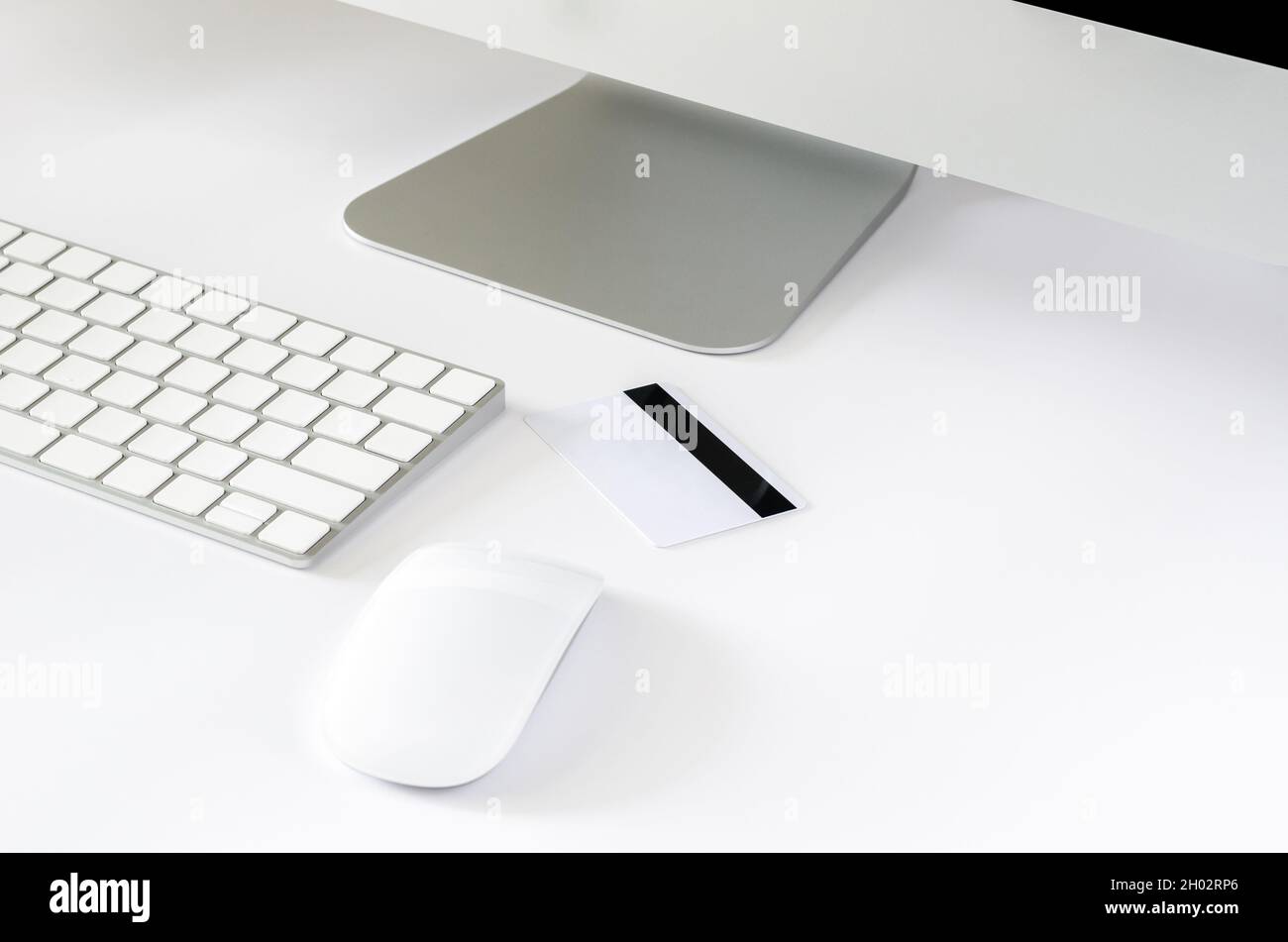 Credit card puts on desk with wireless mouse, keyboard and computer ...