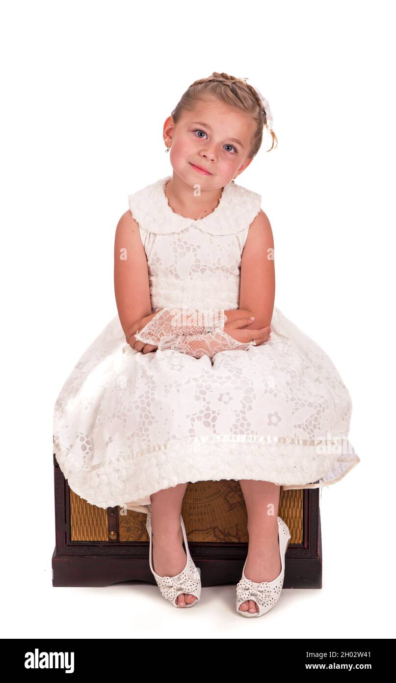 girl and a chest with books. little girl looking inside a trunk with ...