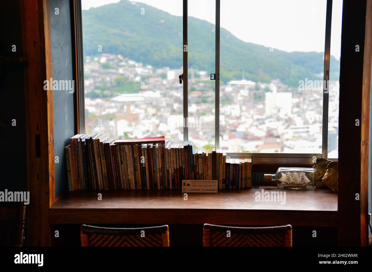 A calm study space overlooking a quaint Japanese mountain village Stock ...