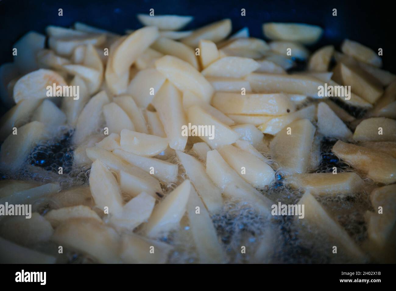 Closeup of a pot full of french fries frying in the oil Stock Photo - Alamy