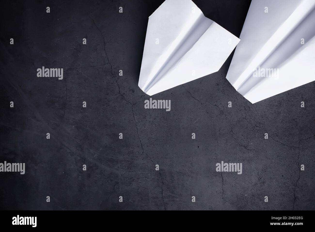 Paper airplane on the table. Origami model on a dark background ...