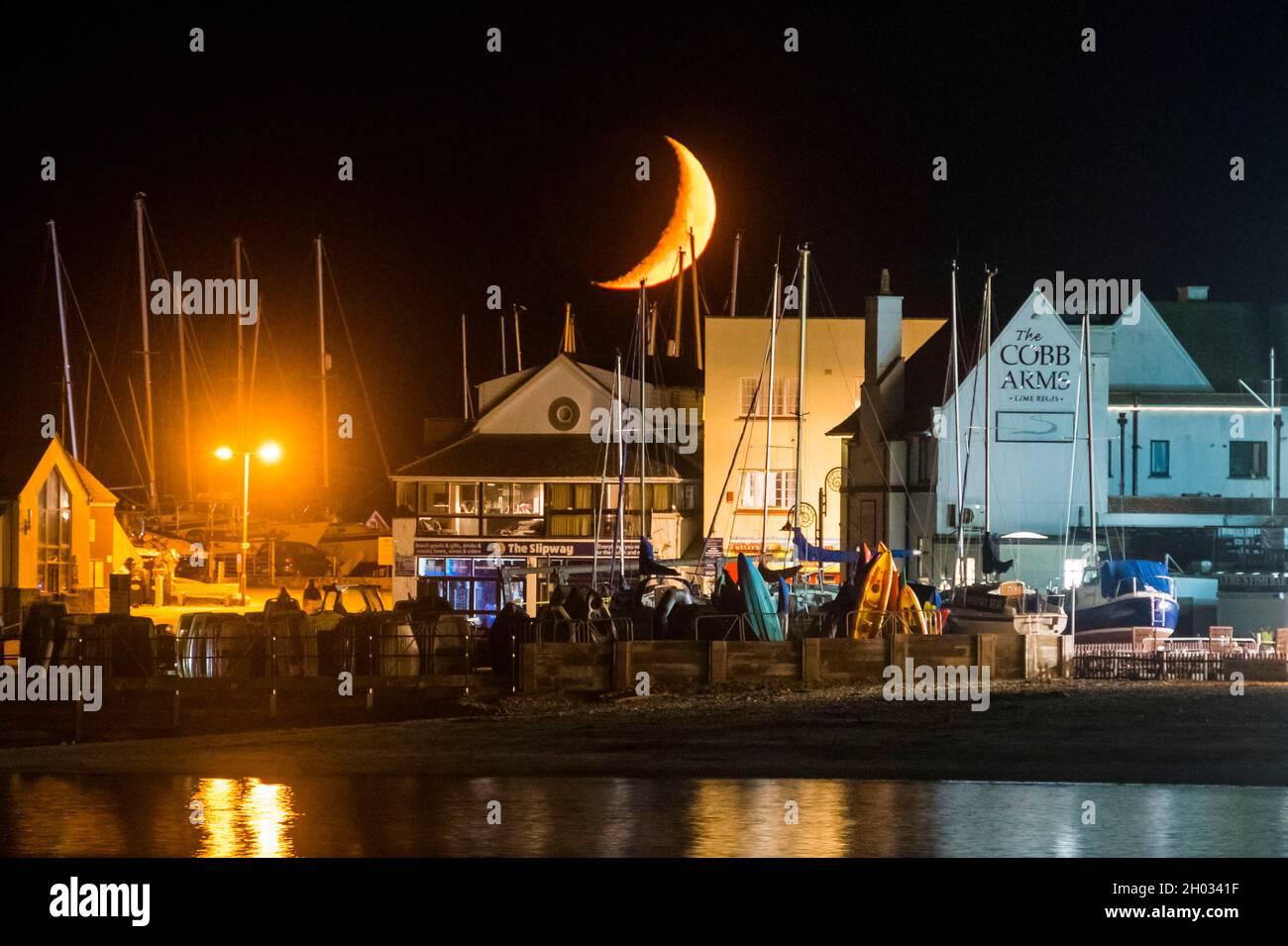 Lyme Regis, Dorset, UK. 10th October 2021. UK Weather. A crescent moon ...