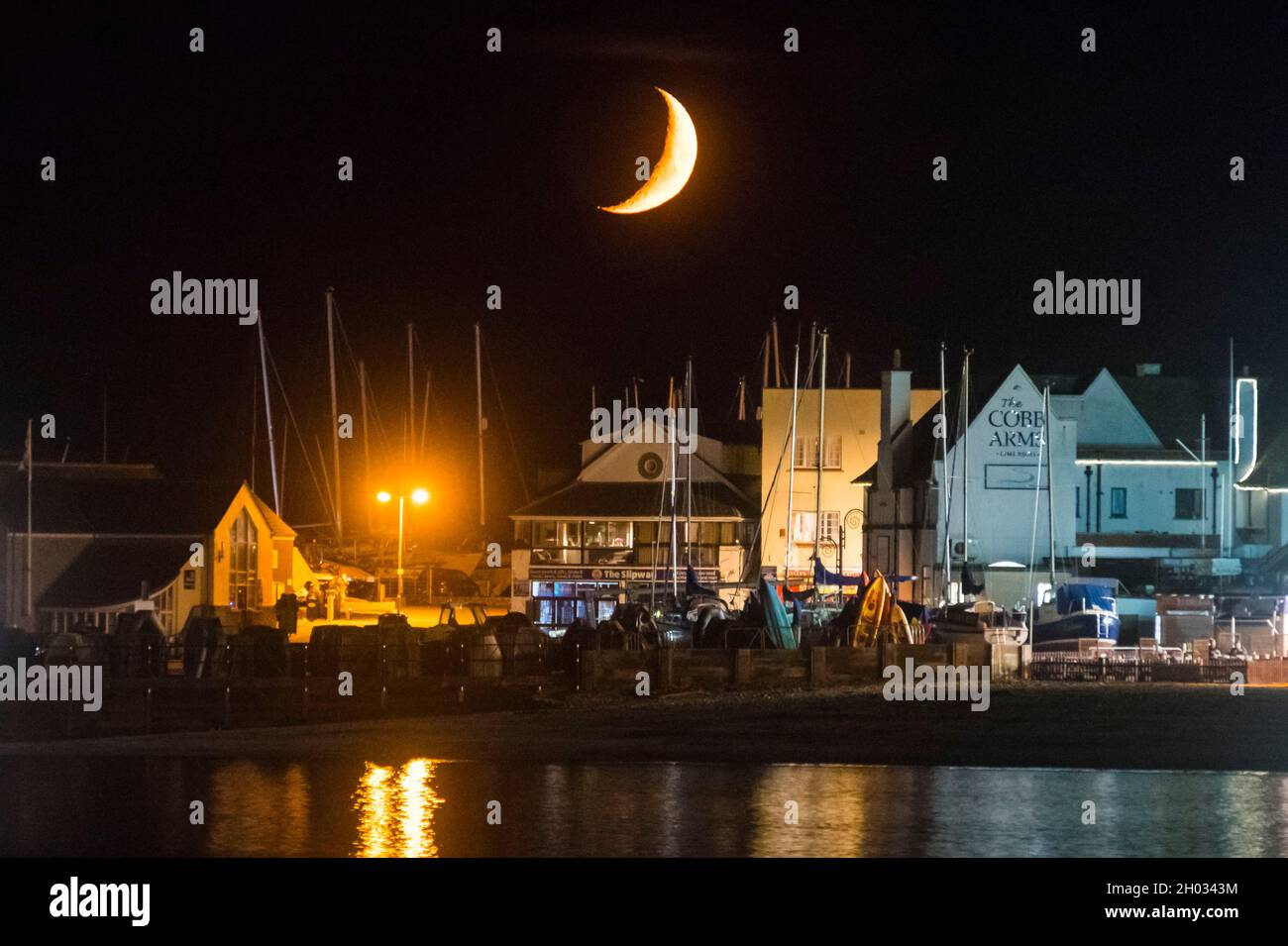 Lyme Regis, Dorset, UK. 10th October 2021. UK Weather. A crescent moon ...