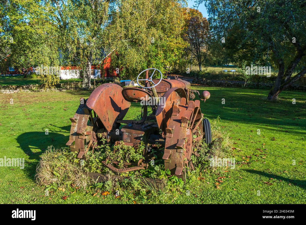 Old rusty tractor with metal wheels Stock Photo - Alamy