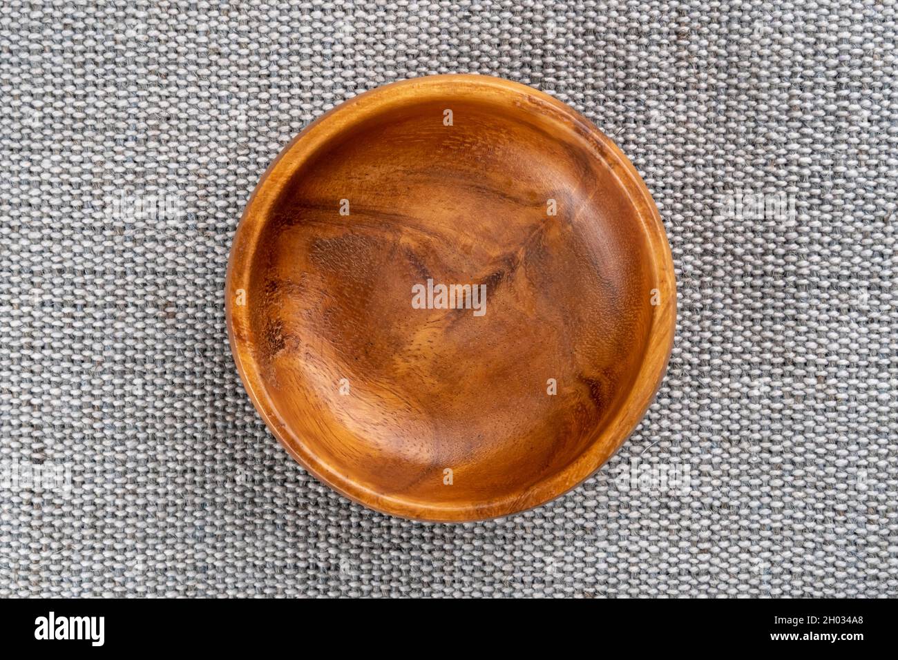 Wooden empty bowl on a jute gray burlap. Top view. Copy space. Rustic ...