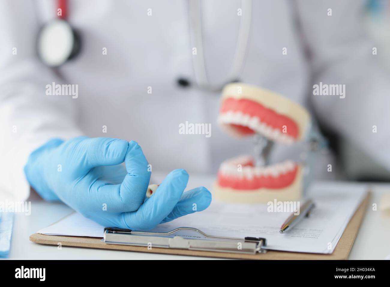 Dentist hand gesture ok on background of artificial jaw Stock Photo - Alamy