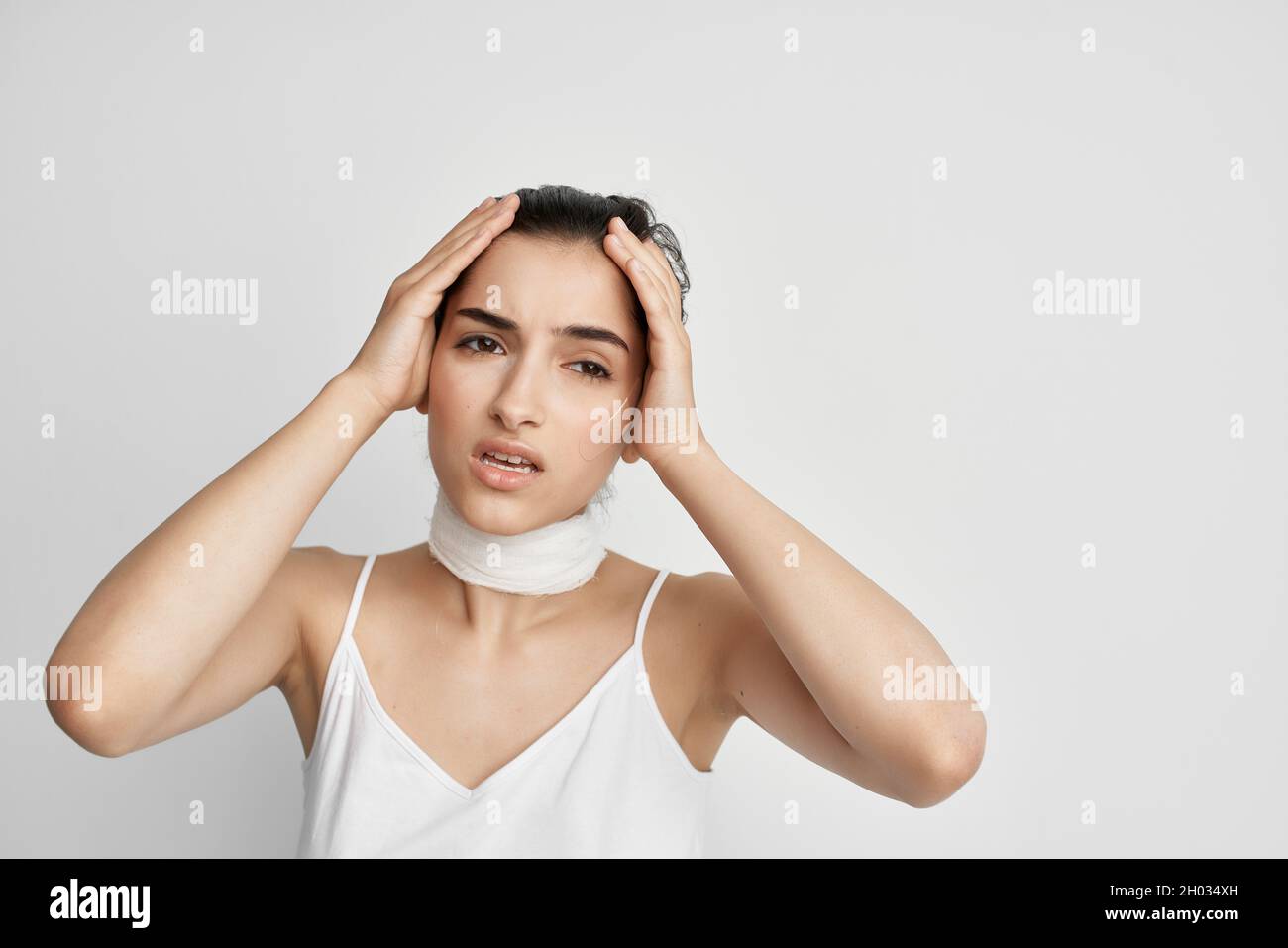 brunette holding his head trauma health problems isolated background ...