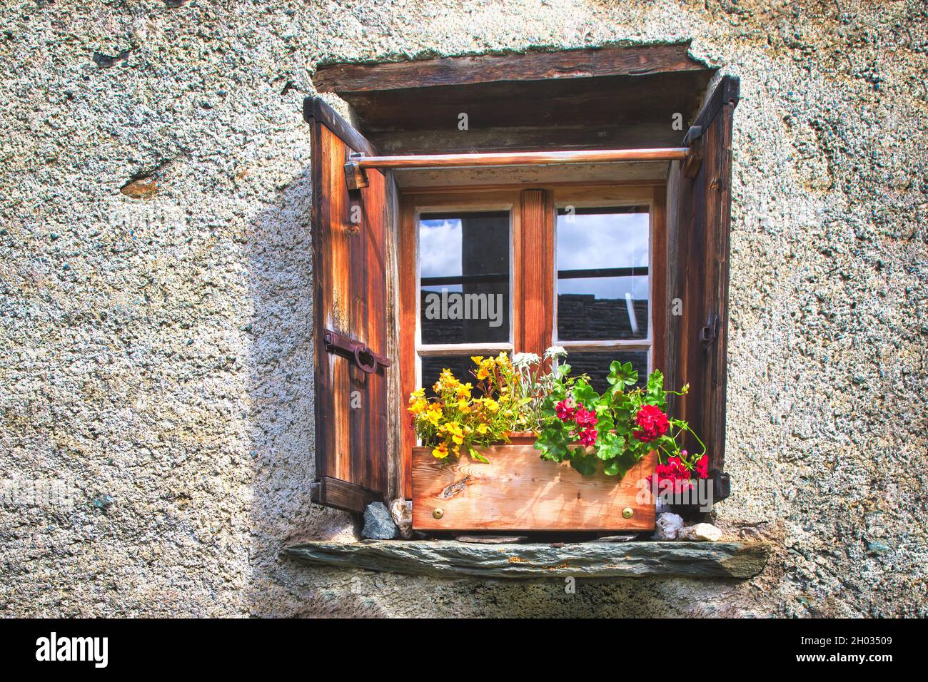 Typical window of the Swiss Alps. With flowers Stock Photo - Alamy