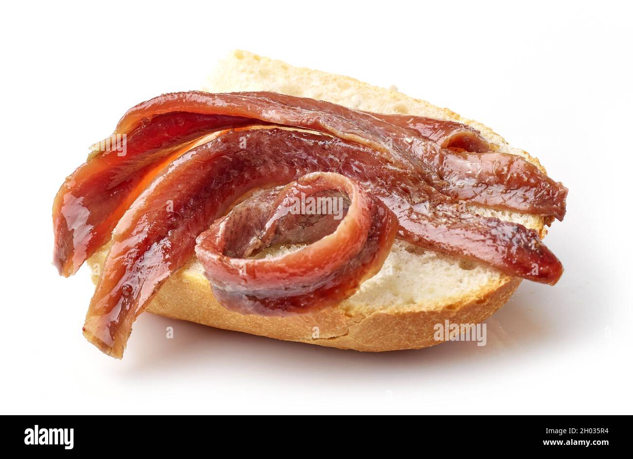 canned anchovy fillets on slice of bread isolated on white background ...