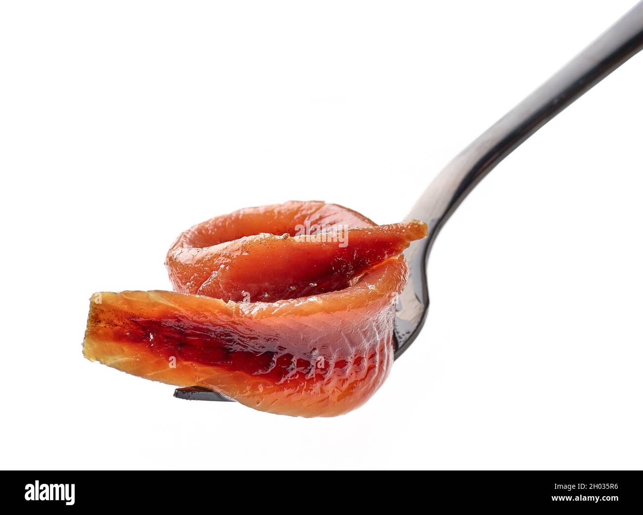 canned anchovy fillet on a fork isolated on white background Stock ...