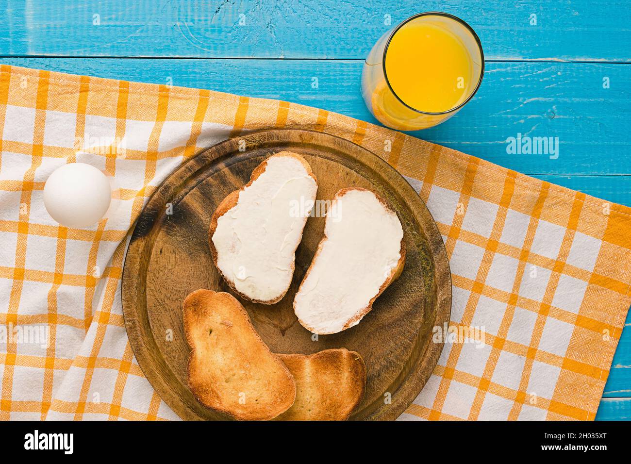 Top view of toast bread and toast butter served with juice on wooden ...