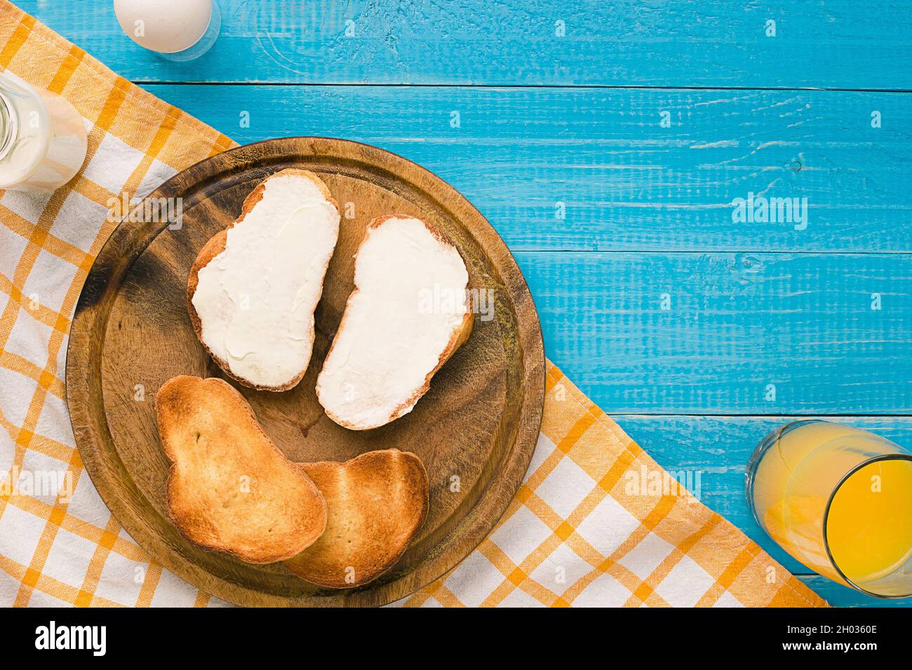 Top view of toast bread and toast butter served with juice on wooden ...