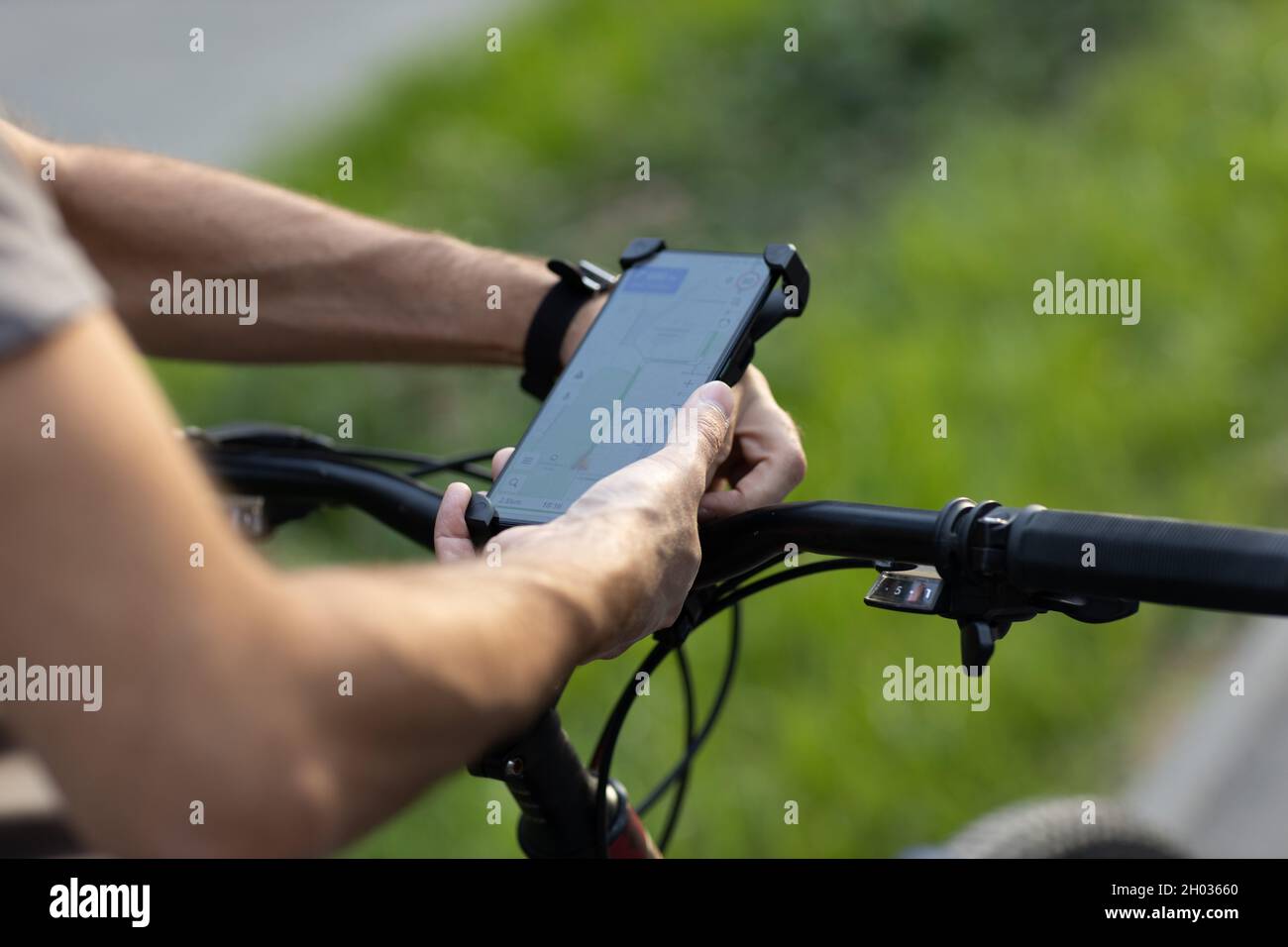 Man planning route using GPS navigation application in mobile phone on ...