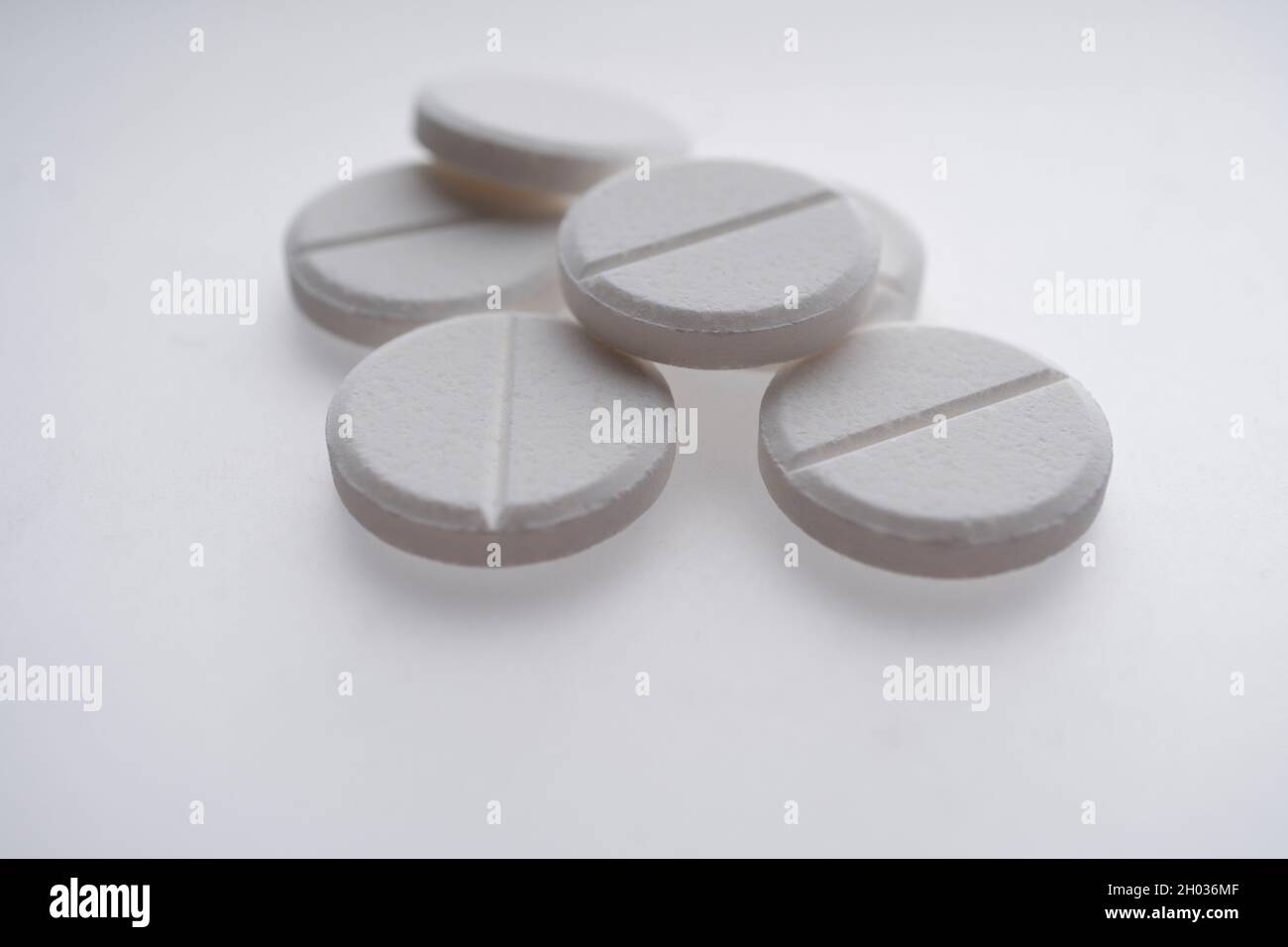 Close up of white pills on white background, medicine and health care ...