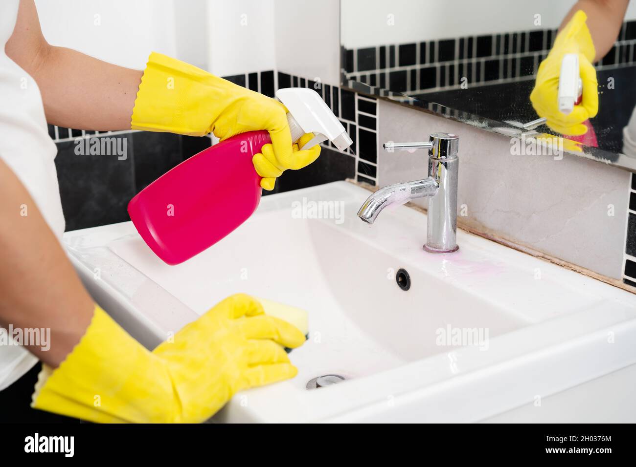 hand cleaning bathroom sink with spray detergent and sponge Stock Photo ...