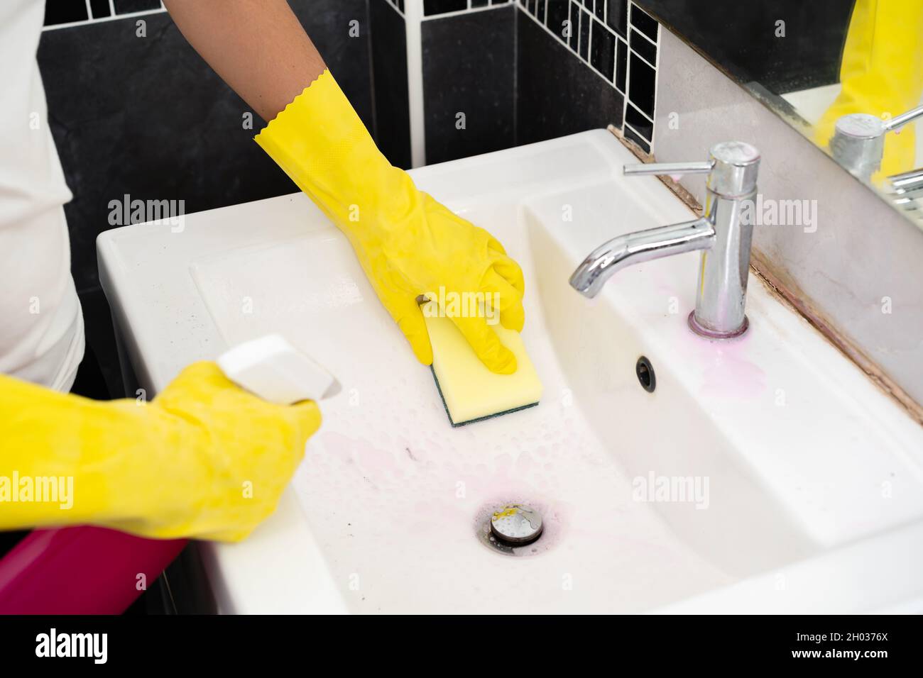 hand cleaning bathroom sink with spray detergent and sponge Stock Photo ...