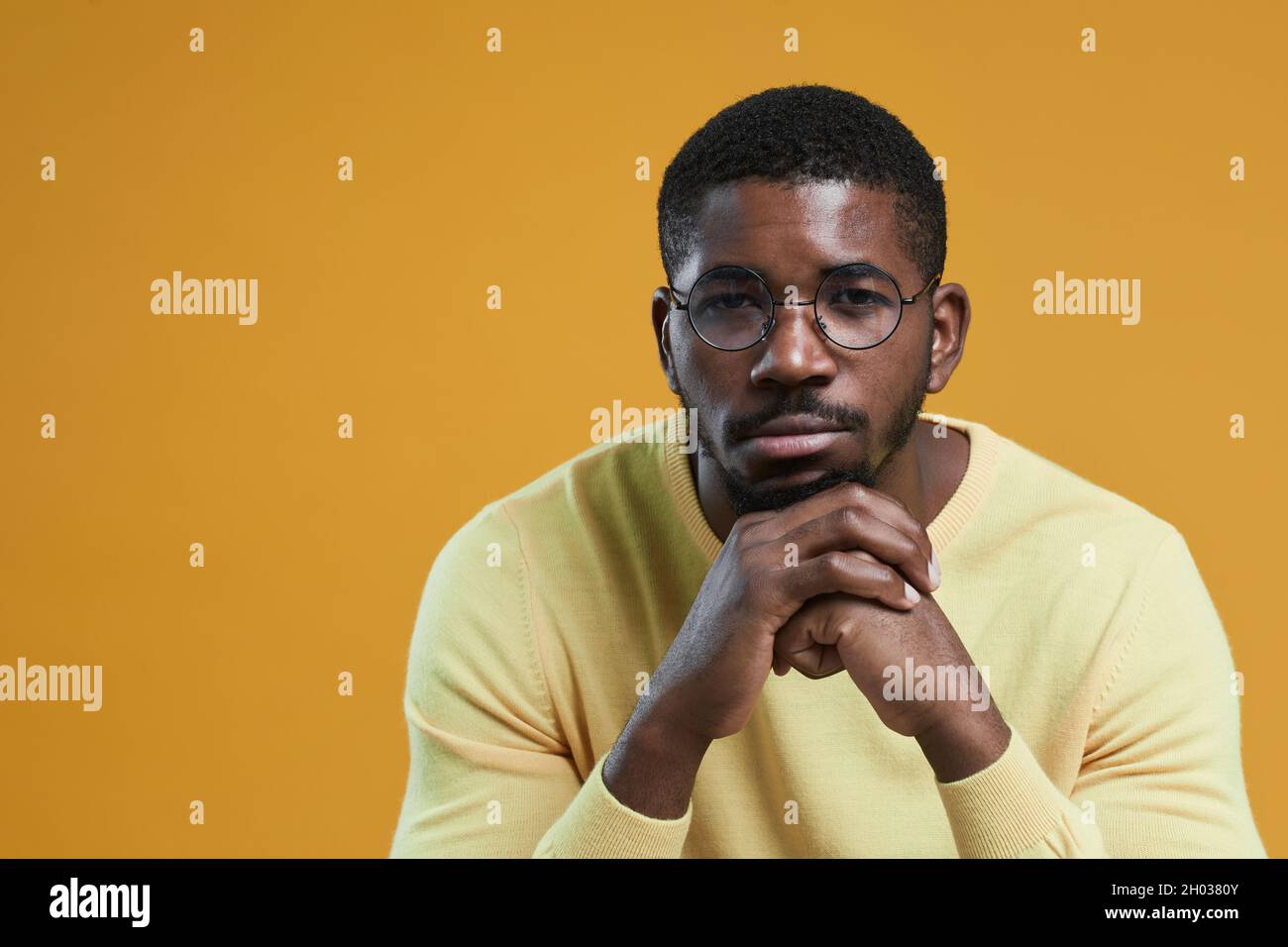 Minimal Portrait Of African American Man Wearing Glasses And Looking At
