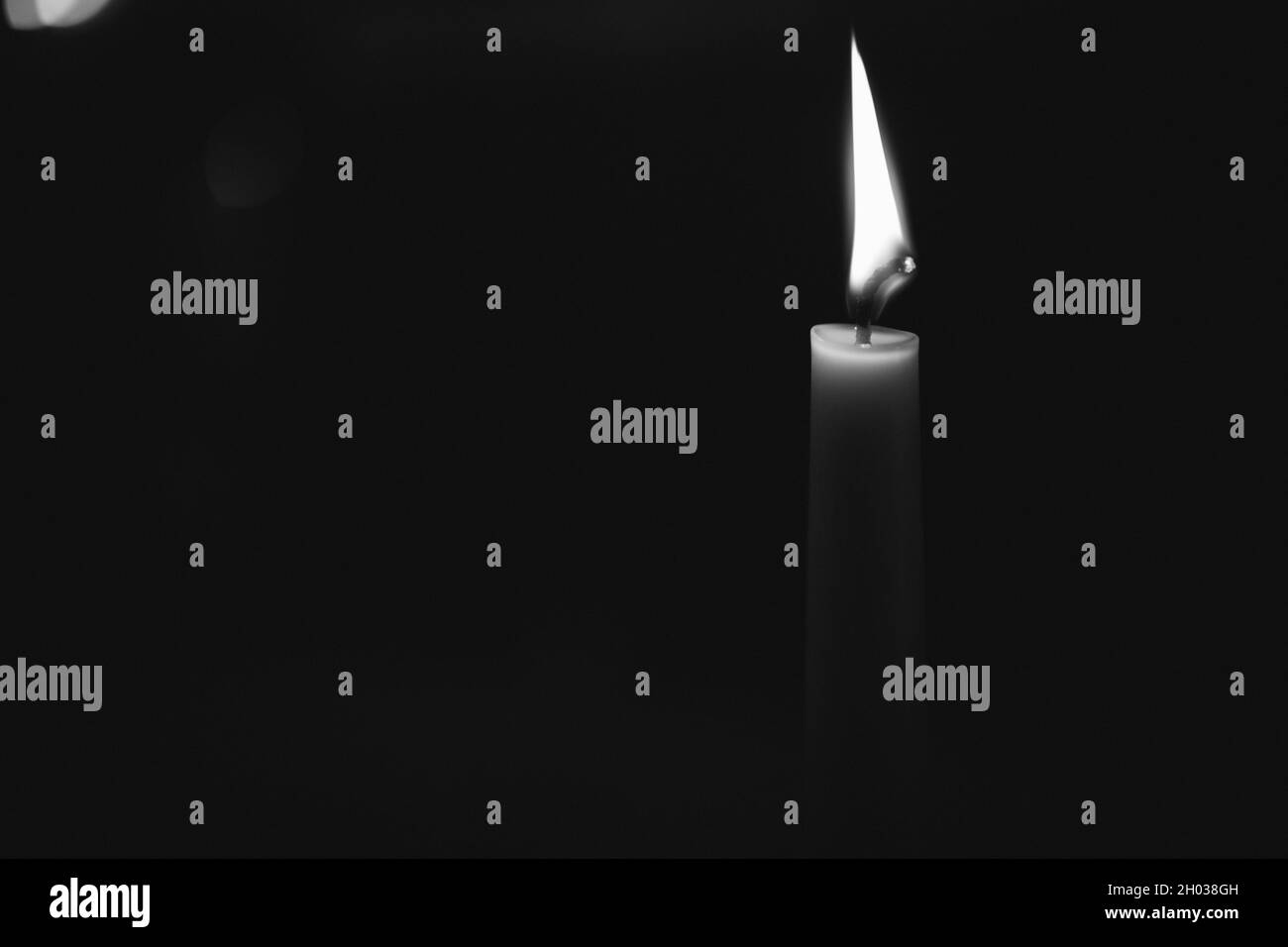 Grayscale of a burning candle isolated on a dark background Stock Photo ...