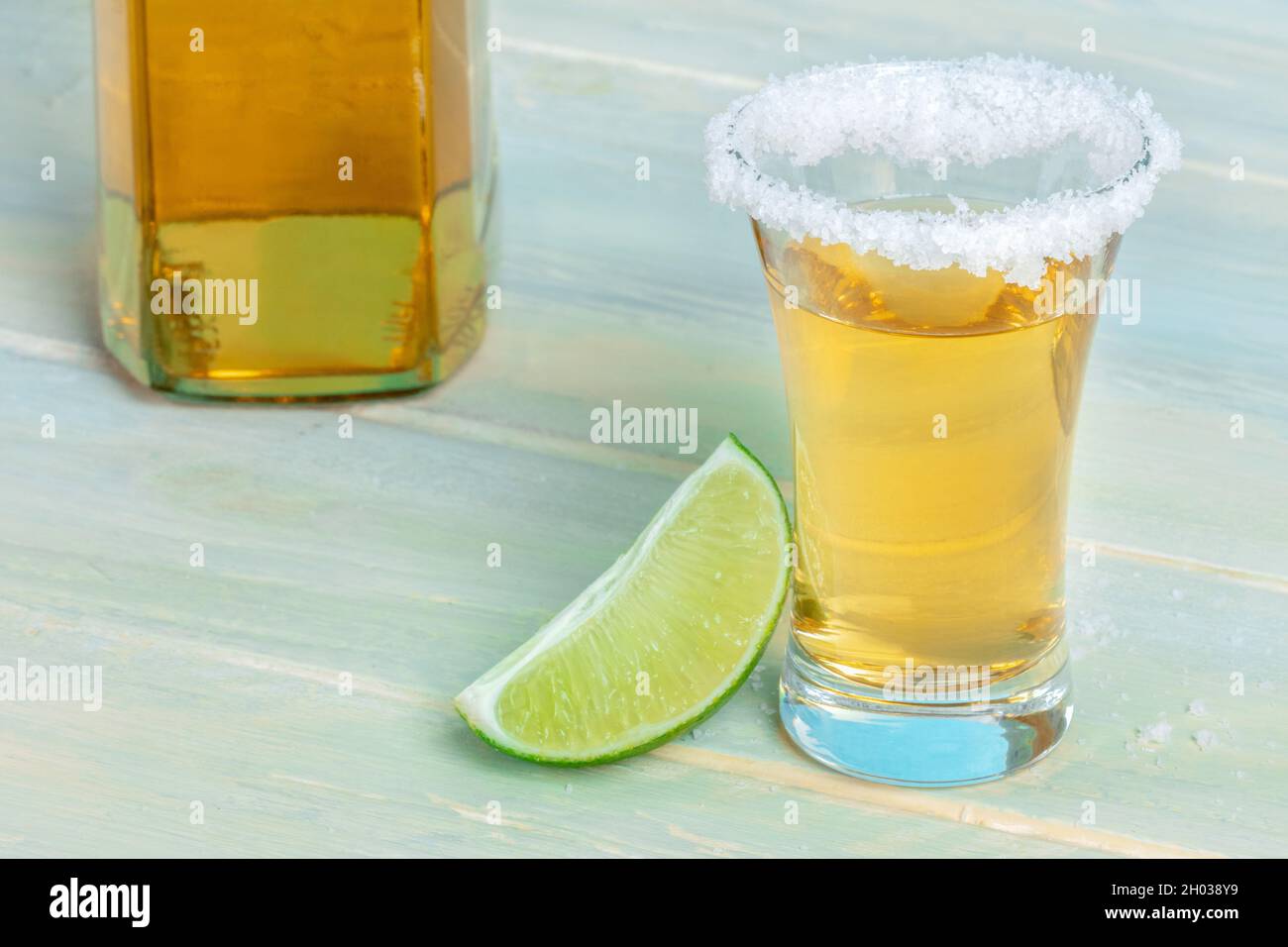 Tequila shot with a lime slice and a bottle, a Mexican drink with a ...