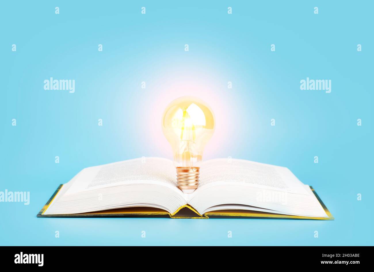 Knowledge study learning concept. Open book with a glowing light bulb ...