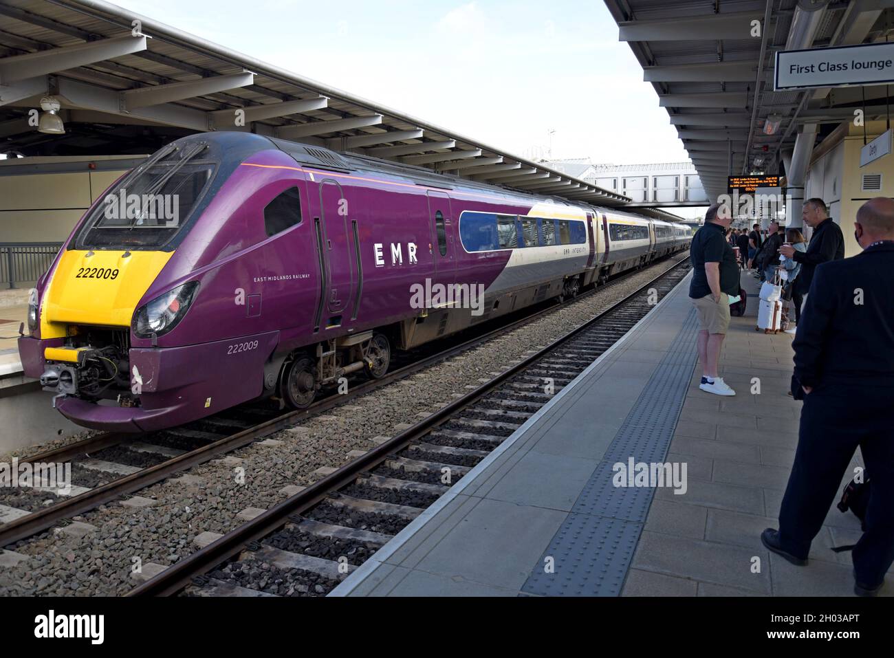 Passengers waiting on the platform at Derby Station, opposite an East ...