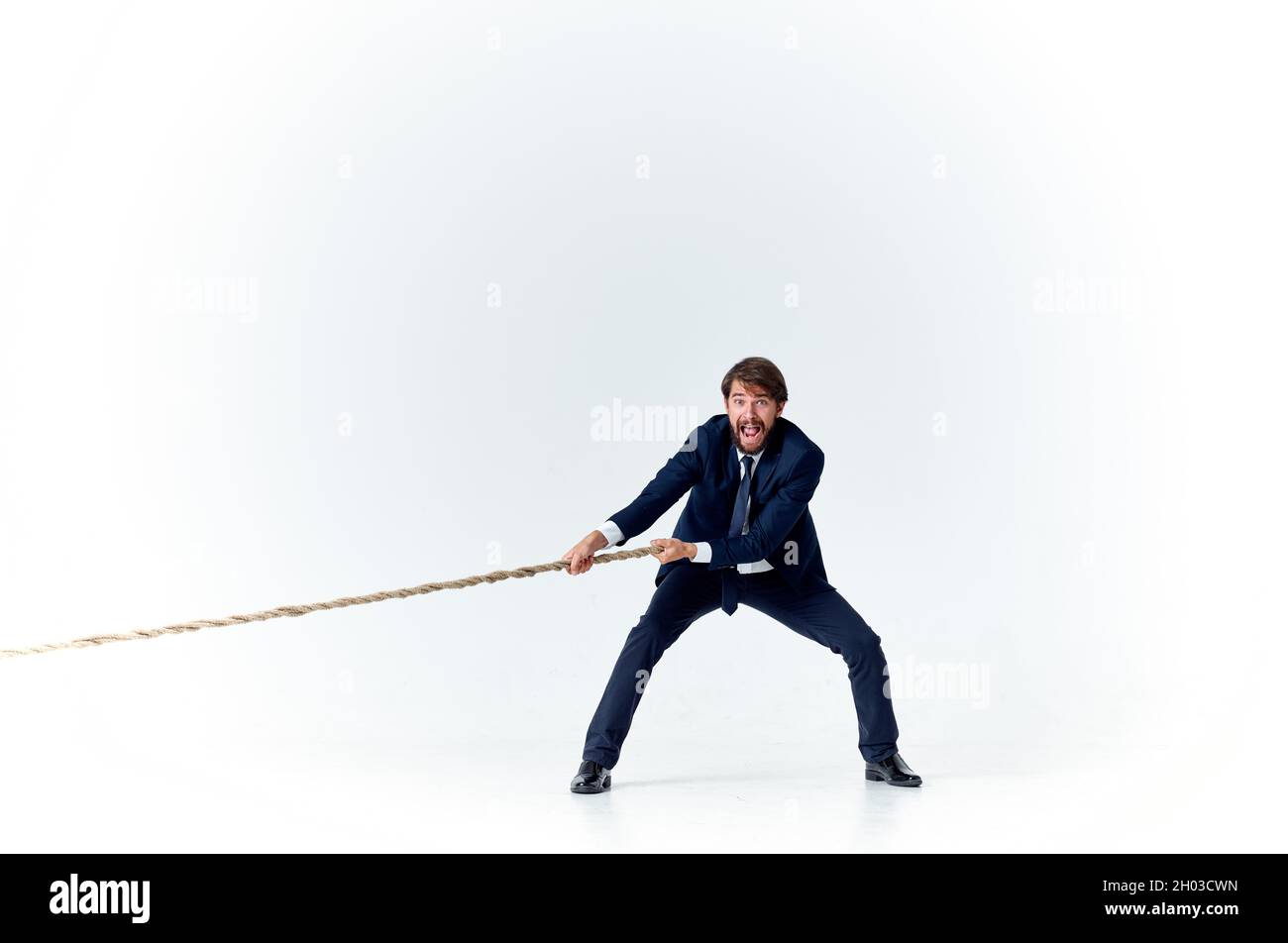 Man in action of pulling rope hi-res stock photography and images - Alamy